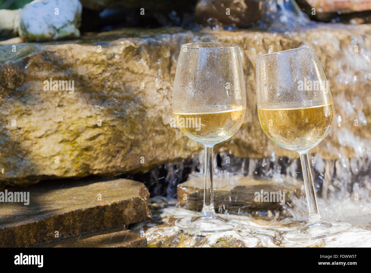 wine cooled in waterfall during hiking break Stock Photo - Alamy