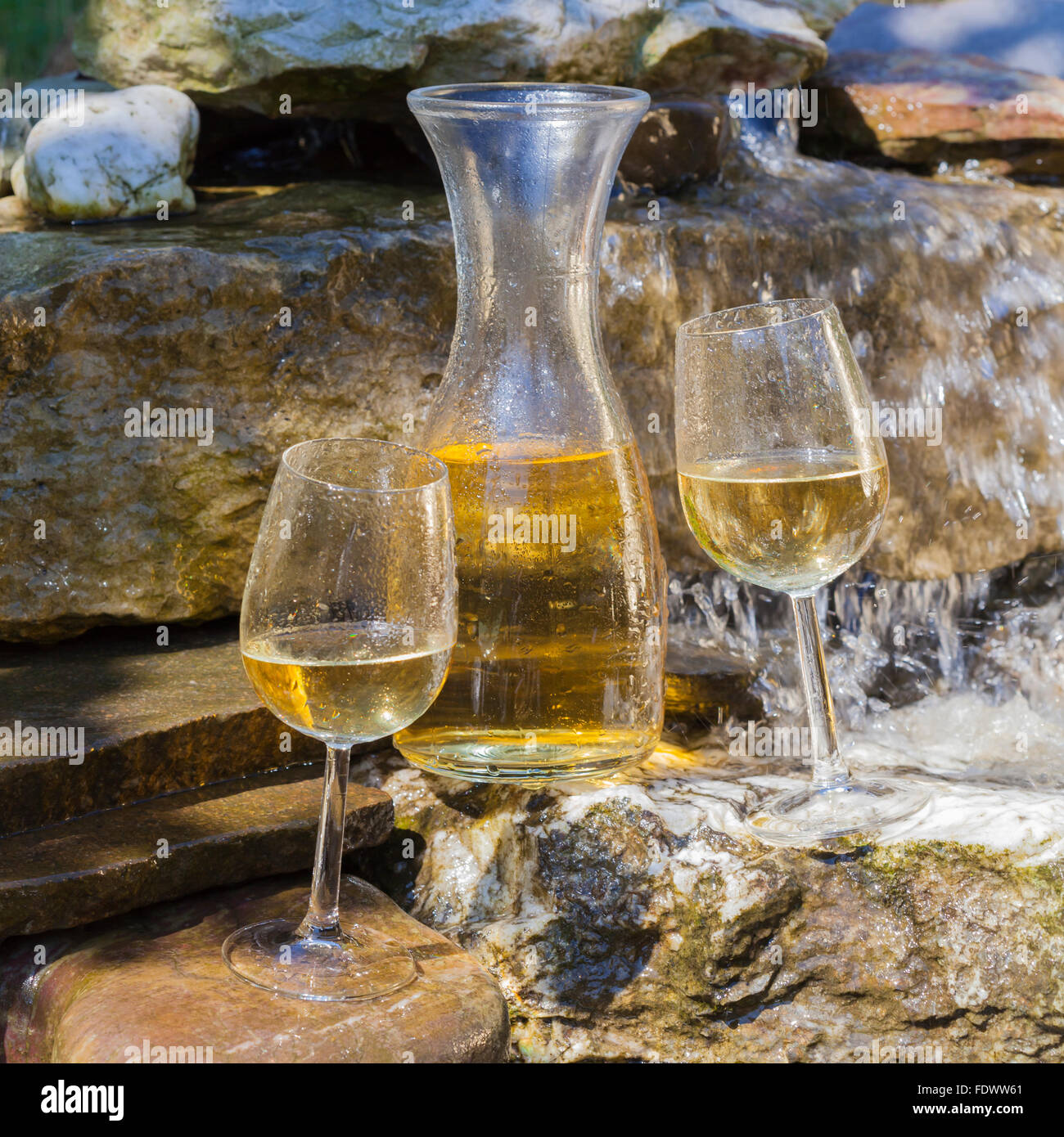 wine cooled in waterfall during hiking break Stock Photo - Alamy