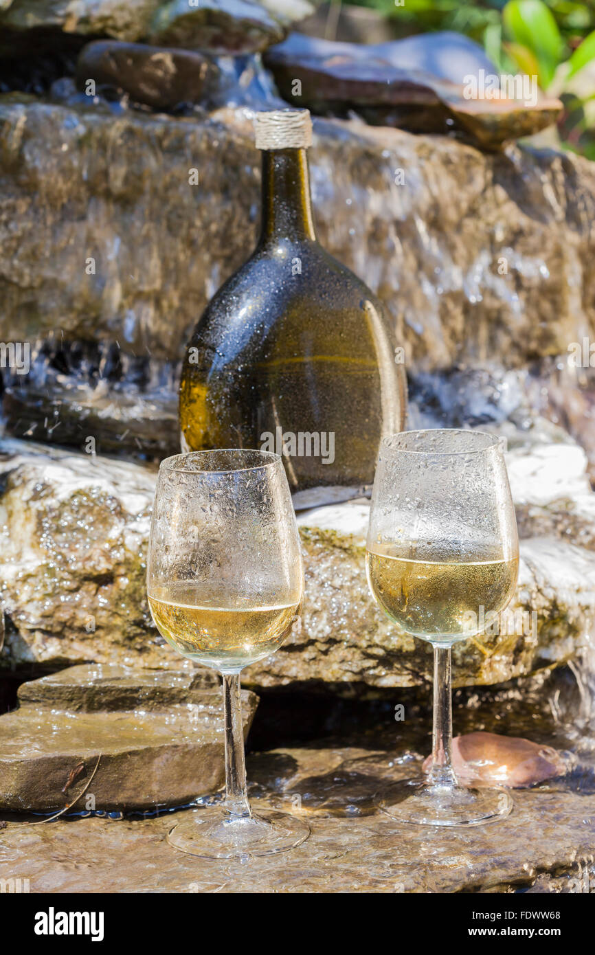 wine cooled in waterfall during hiking break Stock Photo - Alamy