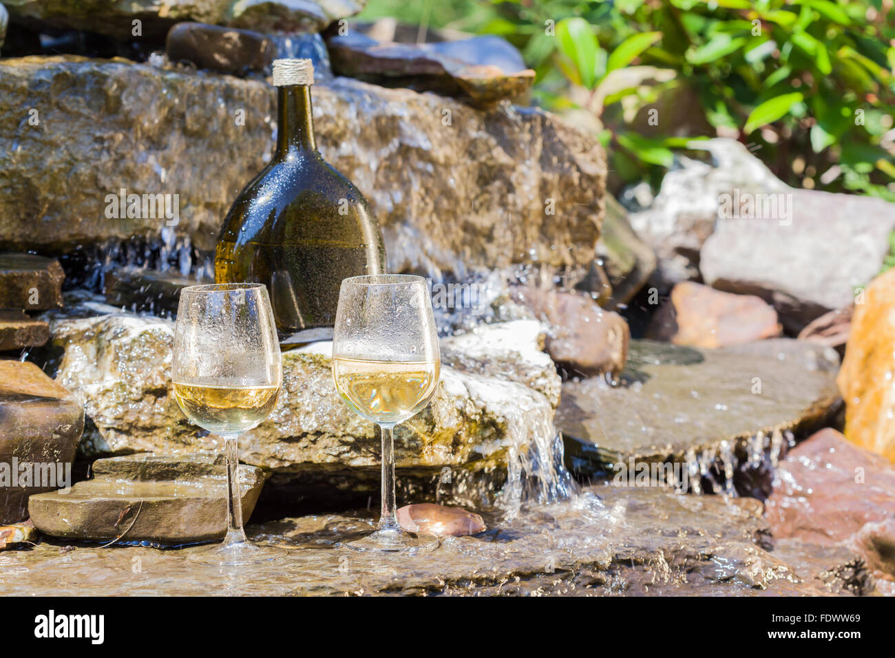 wine cooled in waterfall during hiking break Stock Photo - Alamy