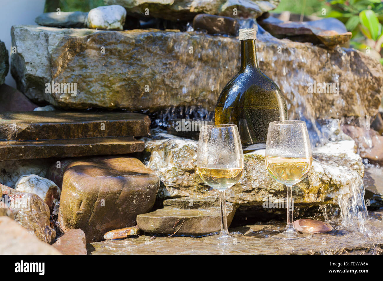 wine cooled in waterfall during hiking break Stock Photo - Alamy