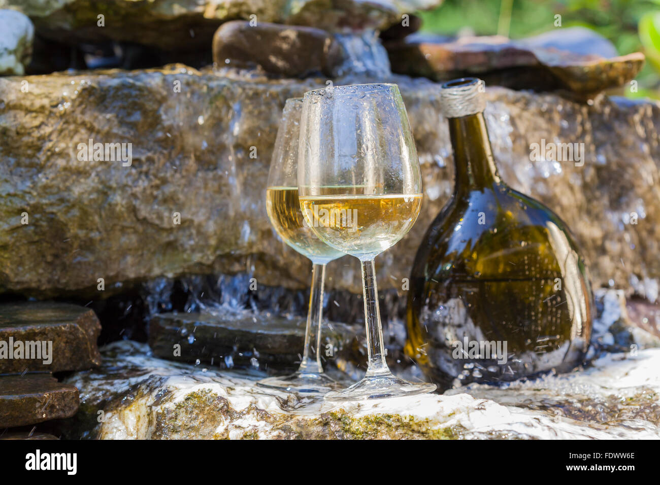 wine cooled in waterfall during hiking break Stock Photo - Alamy