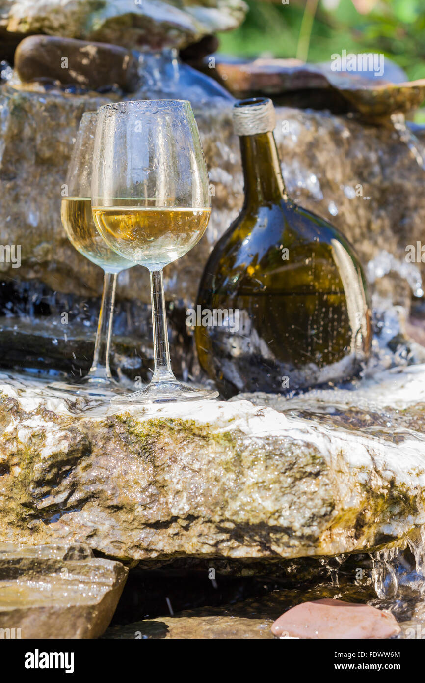 wine cooled in waterfall during hiking break Stock Photo - Alamy