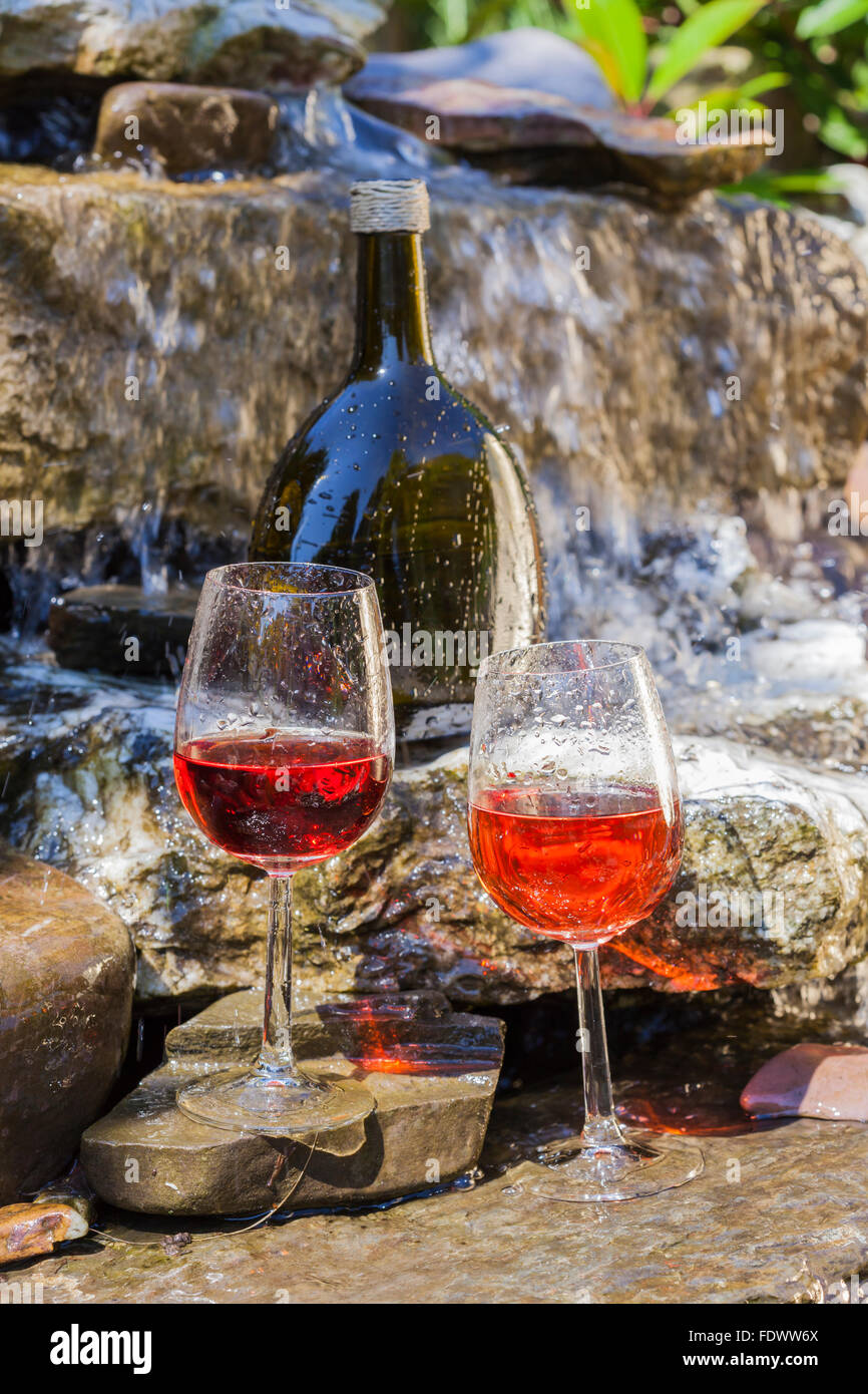 wine cooled in waterfall during hiking break Stock Photo - Alamy