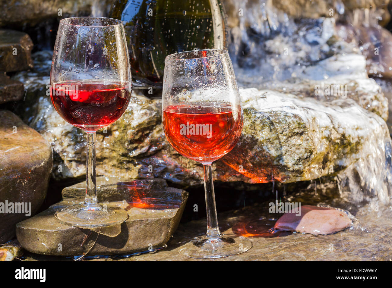 wine cooled in waterfall during hiking break Stock Photo - Alamy