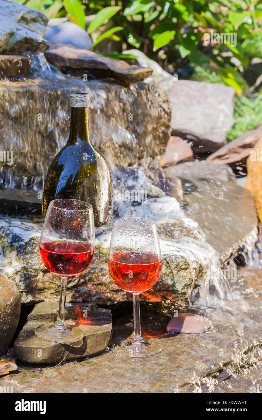 wine cooled in waterfall during hiking break Stock Photo - Alamy
