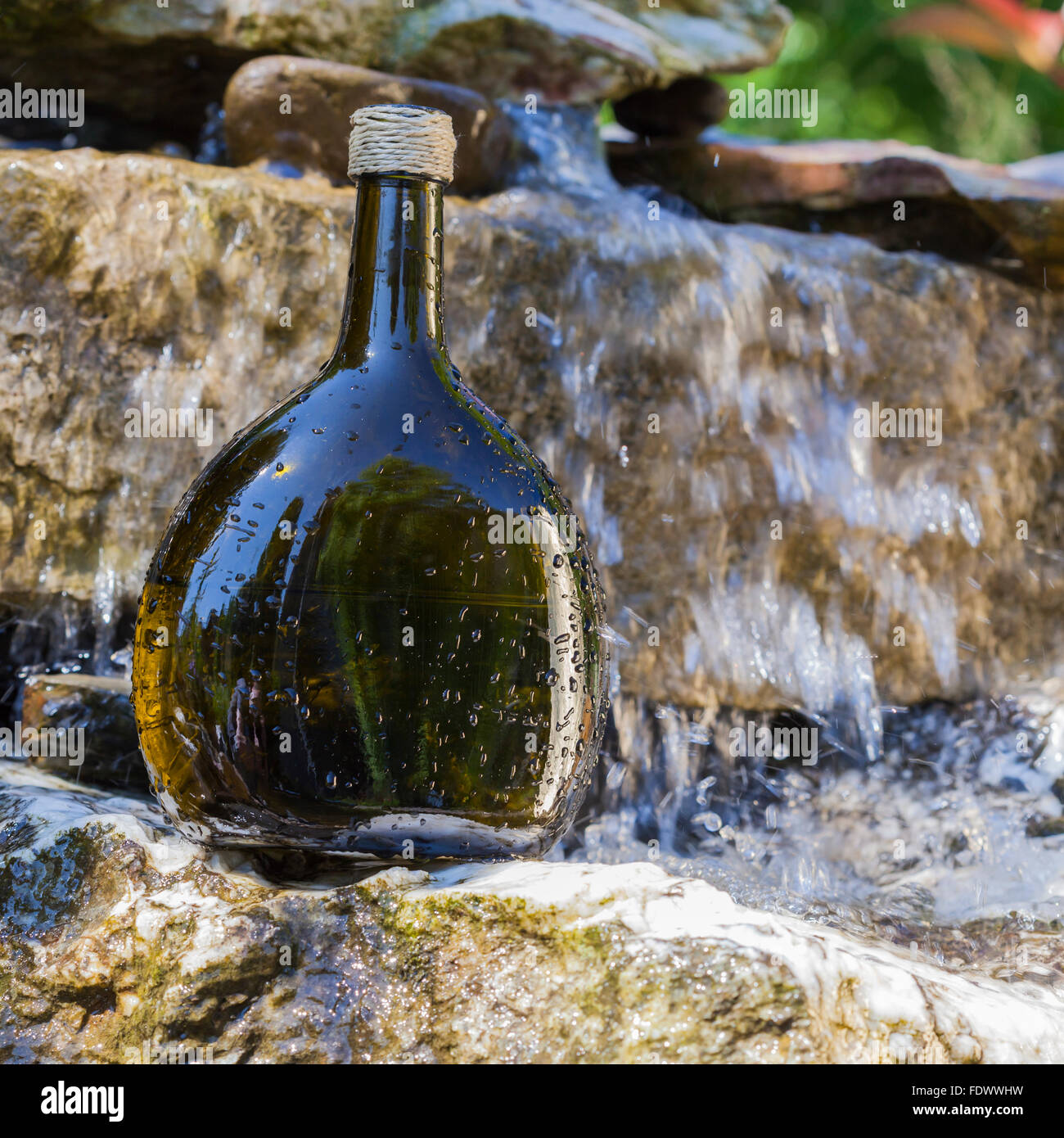 wine cooled in waterfall during hiking break Stock Photo - Alamy