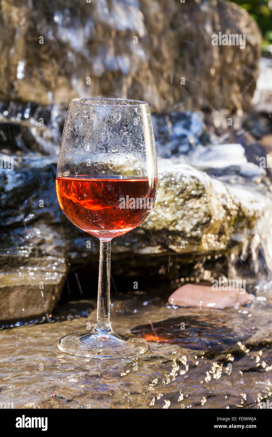 wine cooled in waterfall during hiking break Stock Photo - Alamy