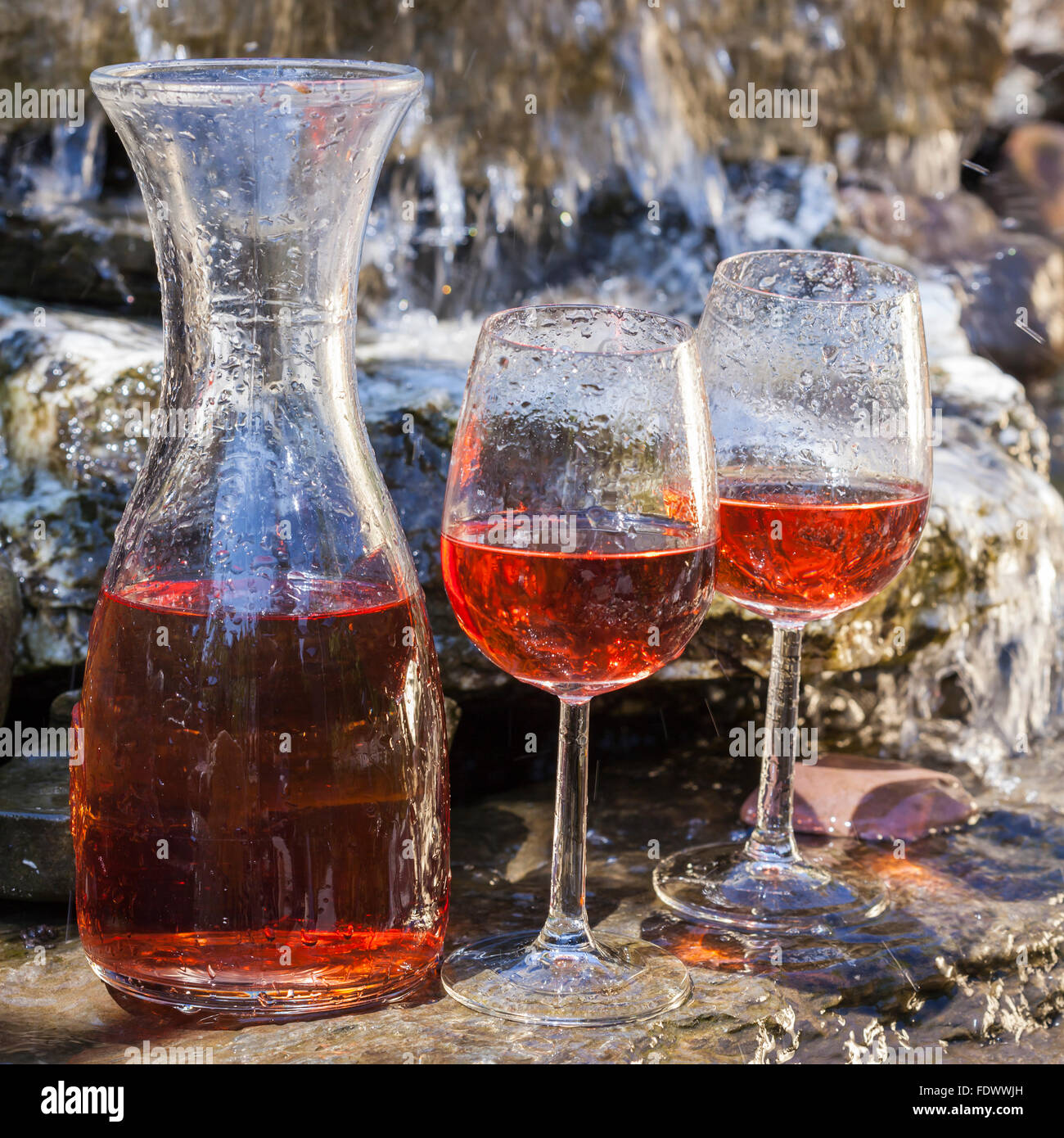 wine cooled in waterfall during hiking break Stock Photo - Alamy