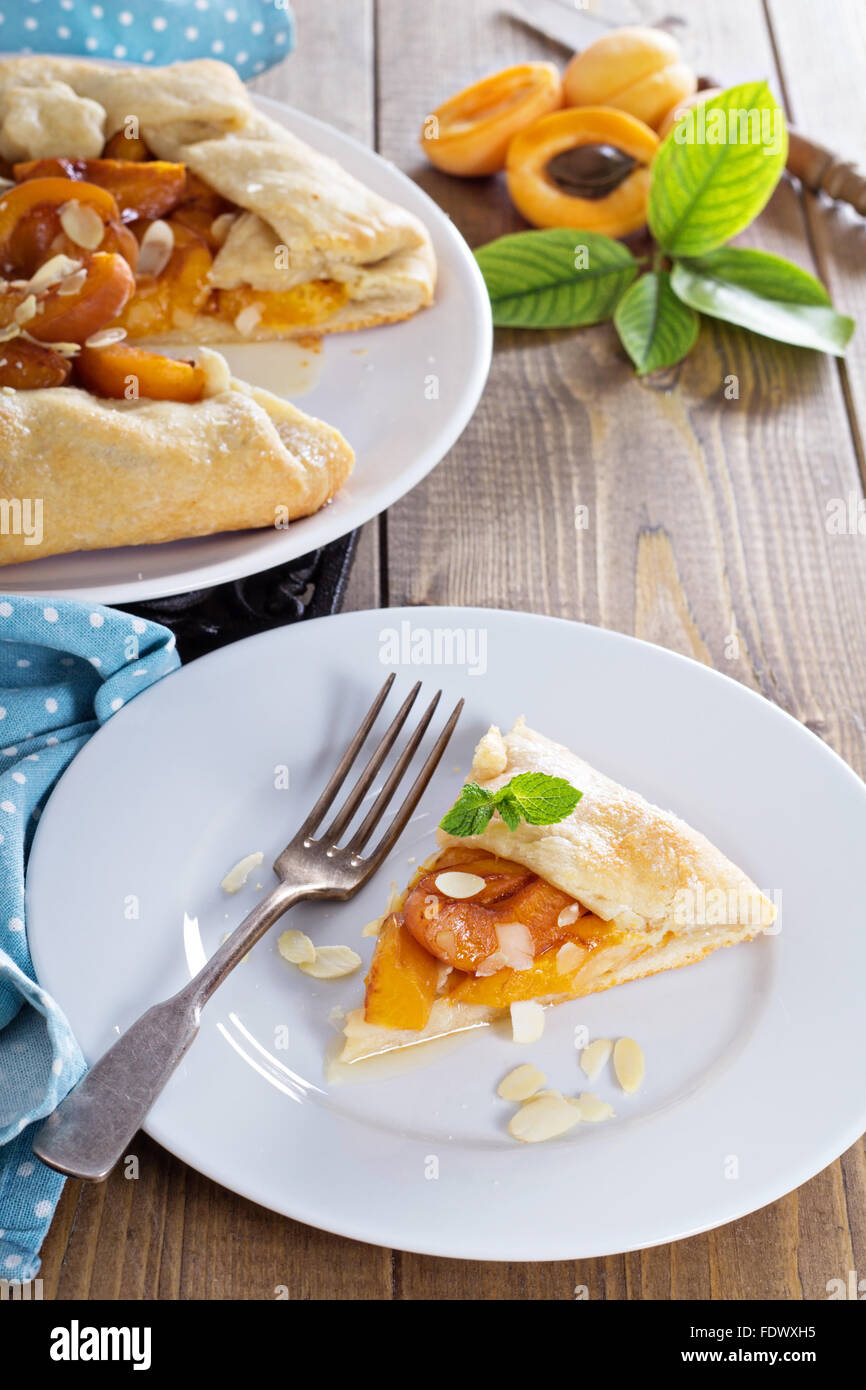 Free form open pie with apricots and almonds Stock Photo - Alamy
