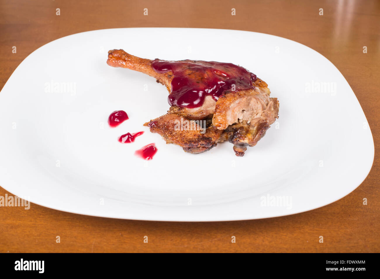 roasted duck leg with raspberry sauce Stock Photo - Alamy