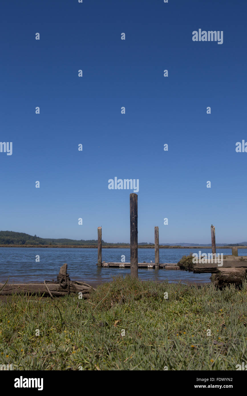 tidal river with mooring posts Stock Photo - Alamy