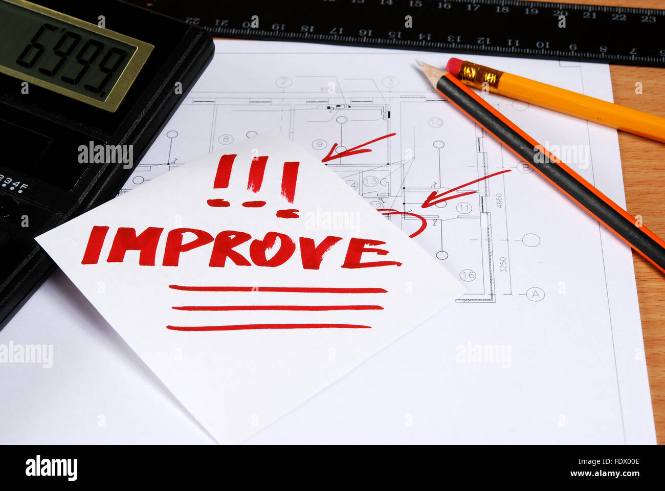 technical drawing with a pencil, a calculator, and a sticker with the ...