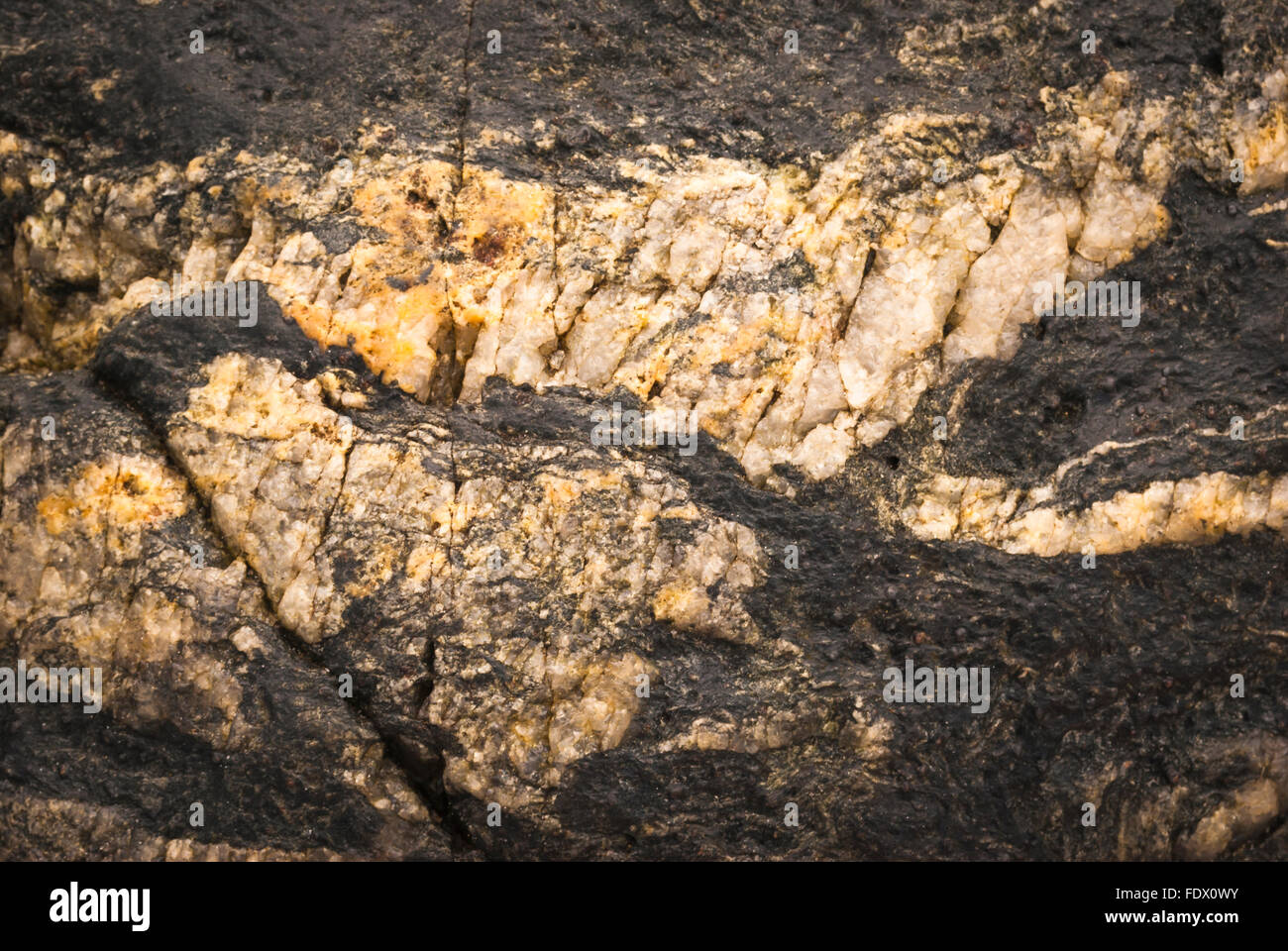 A band of quartz running through the bedrock Stock Photo - Alamy