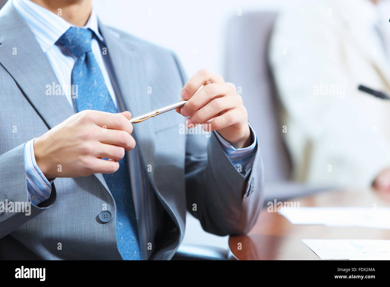 Image of businessman's hands laying on table with pen Stock Photo - Alamy