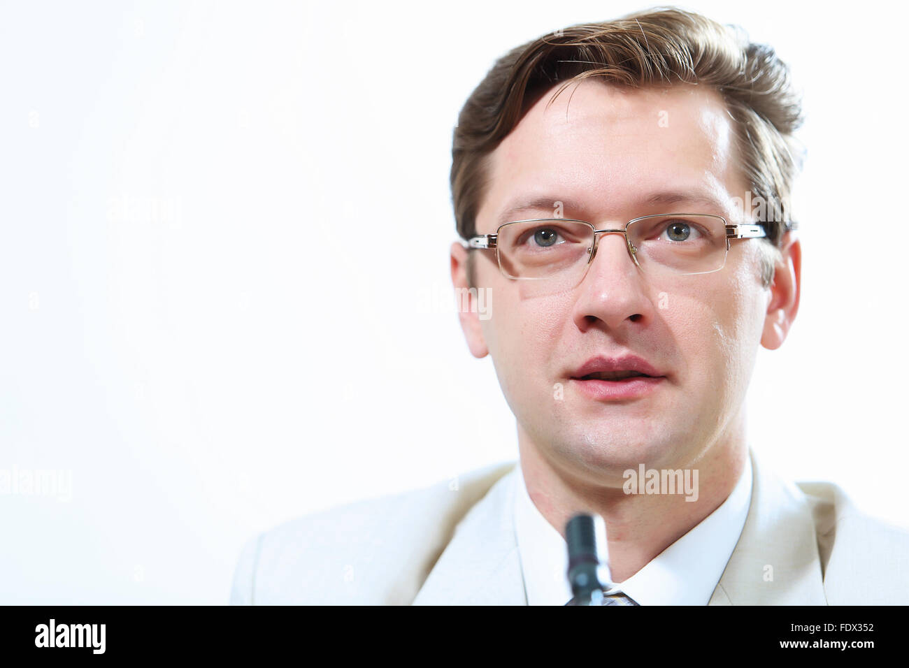 Image of young businessman speaking in microphone at business meeting ...