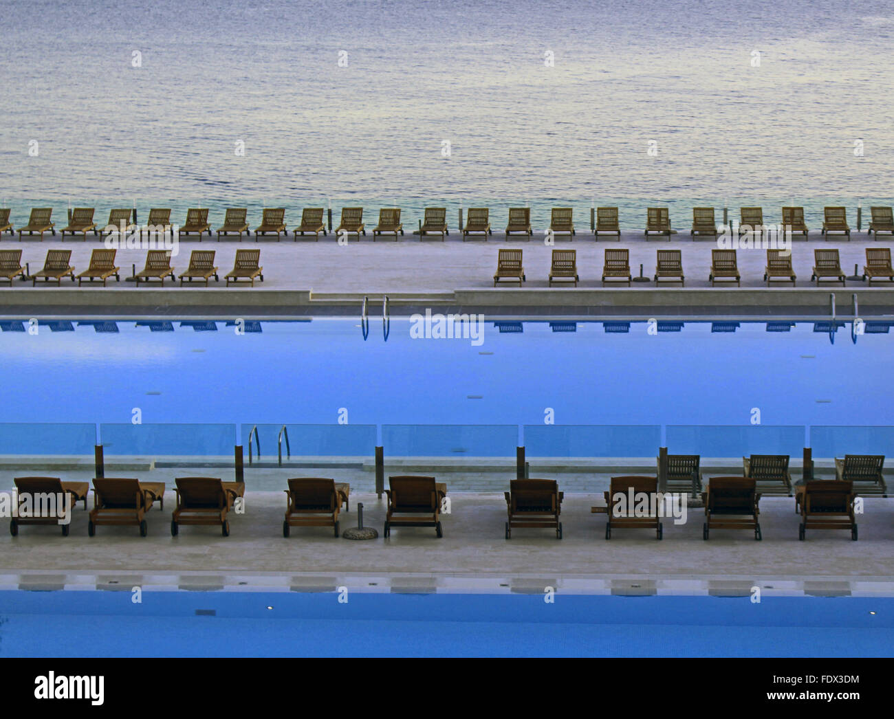 Relaxed atmosphere and blue sunset at infinity swimming pools in ...