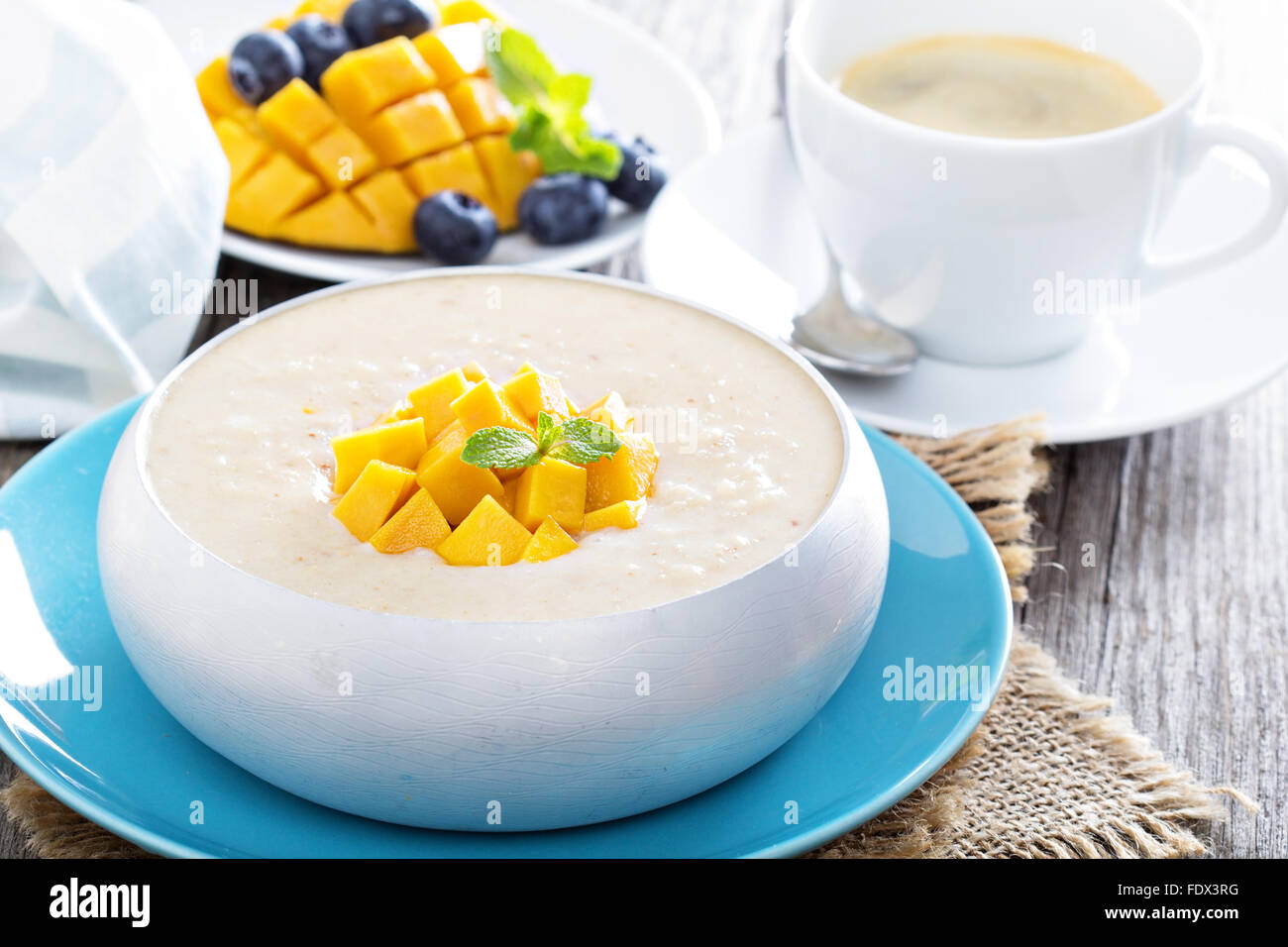 Coconut mango rice pudding served for breakfast Stock Photo - Alamy