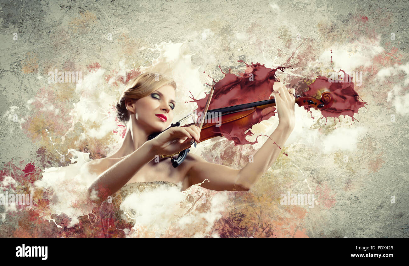 Image of beautiful female violinist playing with closed eyes against ...