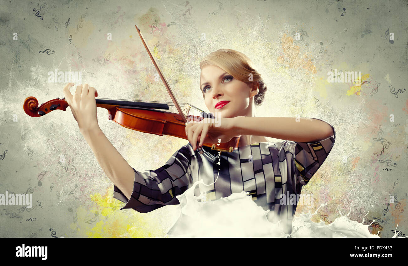 Image of beautiful female violinist playing against splashes background ...
