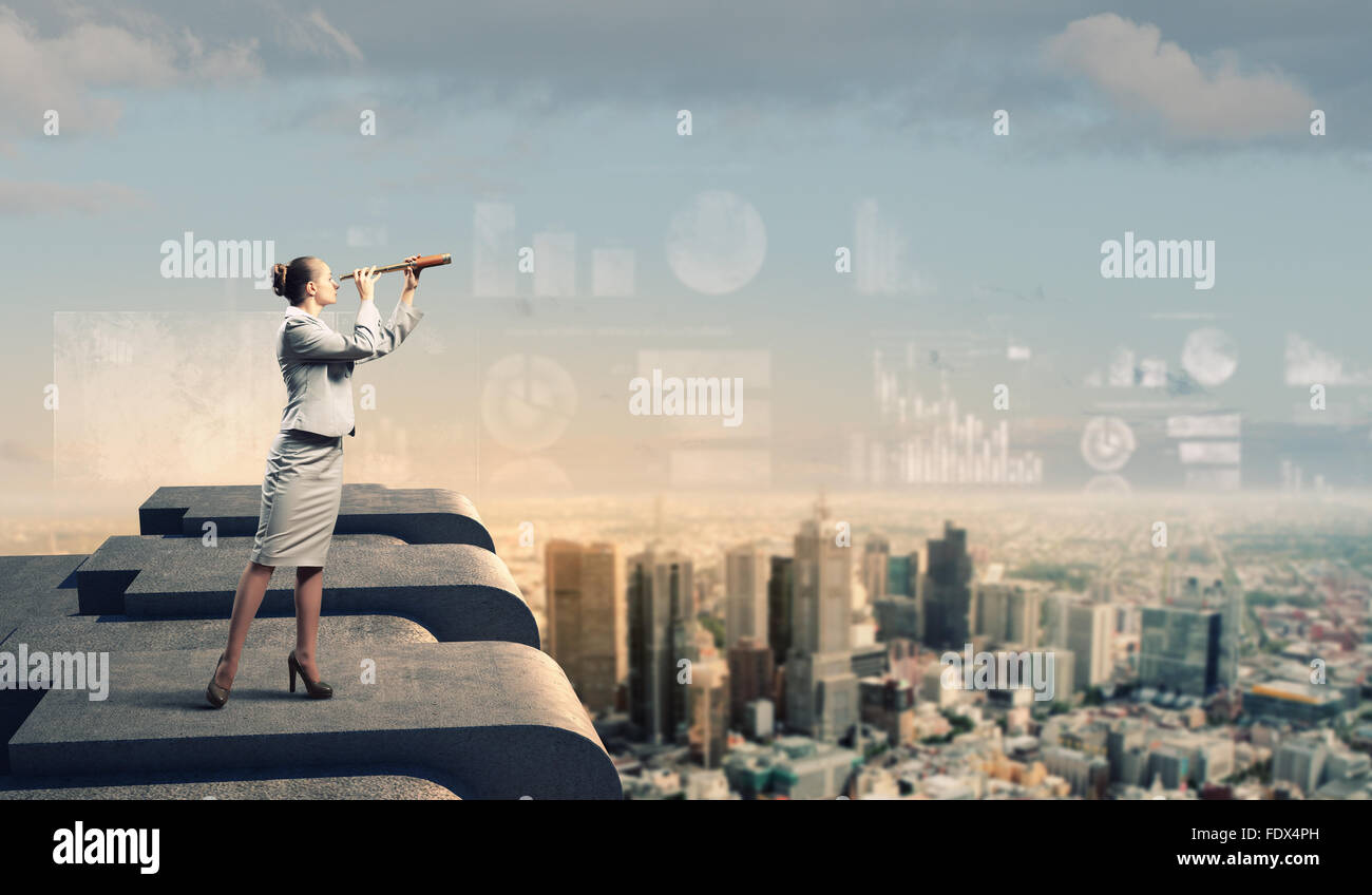 Image of businesswoman looking in telescope standing a top of building ...