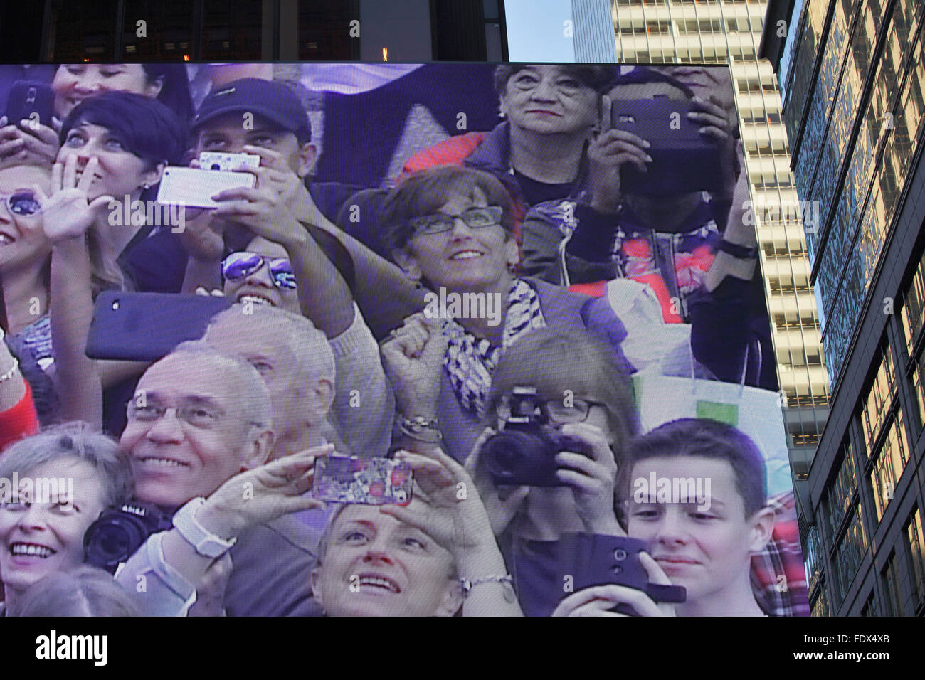 New York City, USA, passersby look at Times Square on the overhead ...