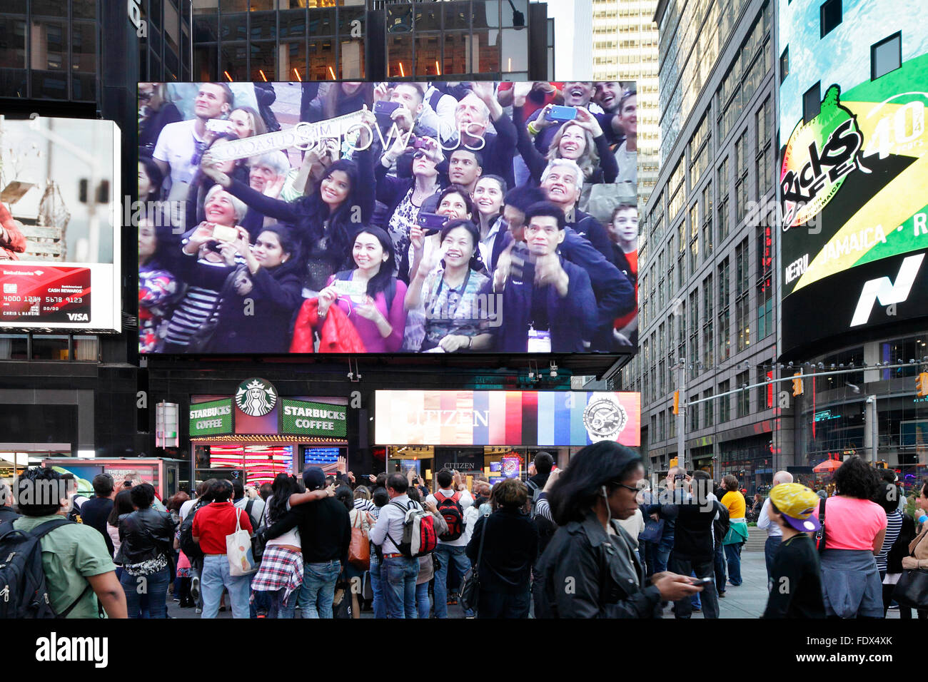 New York City, USA, passersby look at Times Square on the overhead ...