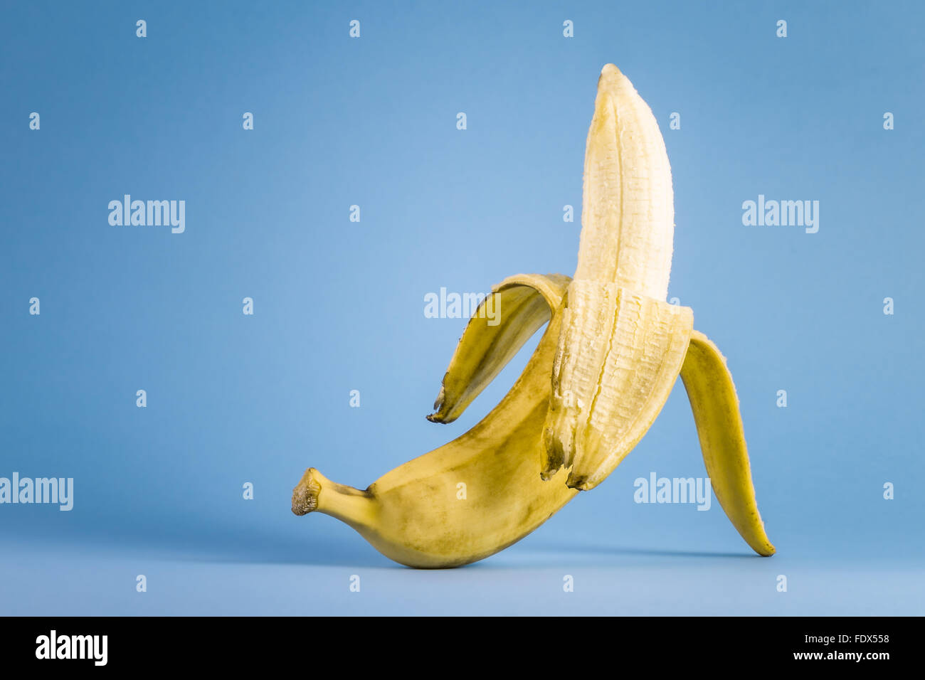 Banana on blue background Stock Photo - Alamy