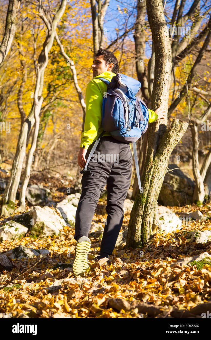 Young man hiking in the forest Stock Photo - Alamy