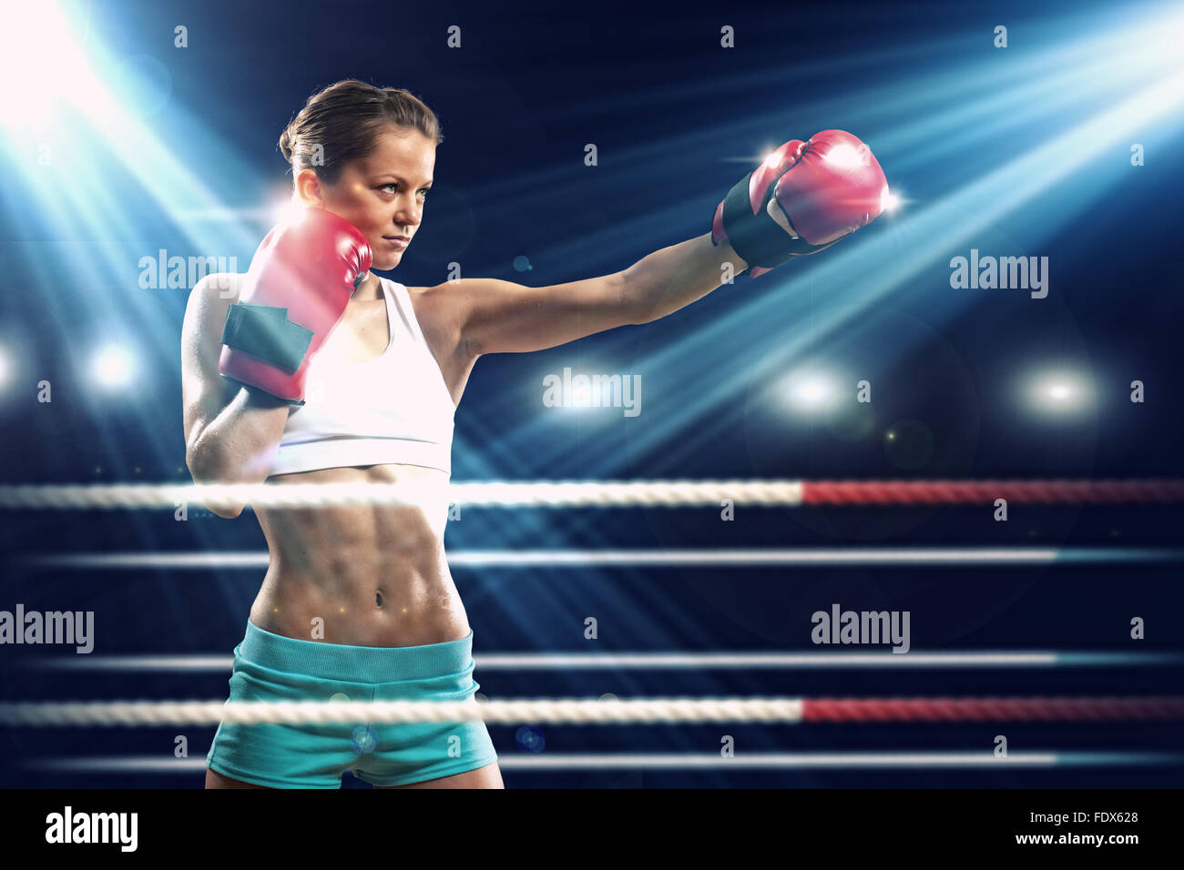 Young pretty boxer woman standing on ring Stock Photo - Alamy
