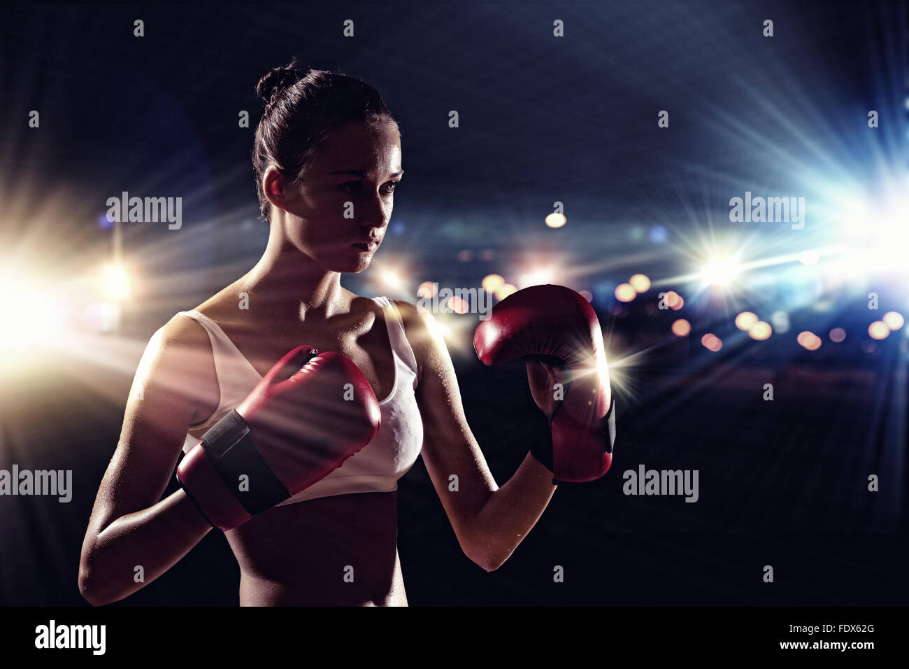 Young pretty boxer woman standing in light flashes Stock Photo - Alamy