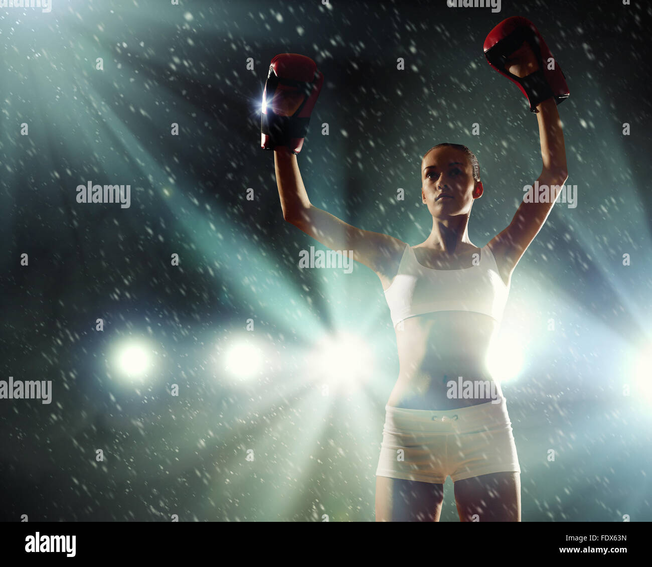 Young pretty boxer woman standing in light flashes Stock Photo - Alamy