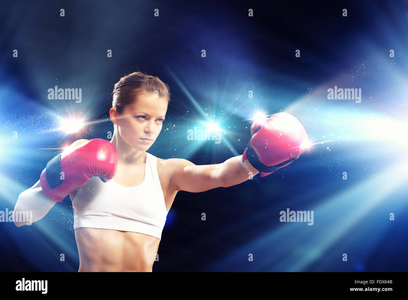 Young pretty boxer woman standing in light flashes Stock Photo - Alamy