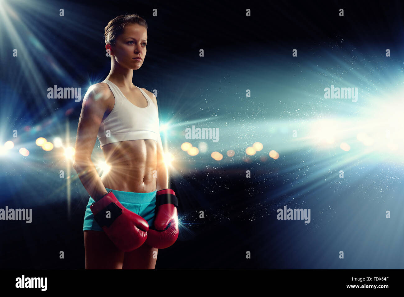 Young pretty boxer woman standing in light flashes Stock Photo - Alamy