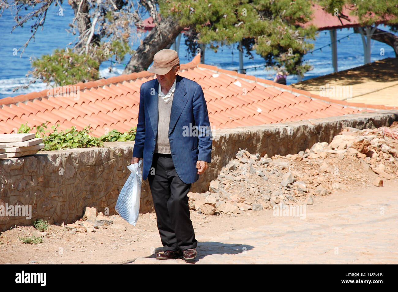 Local man walking alone in Hydra, Greece Stock Photo - Alamy