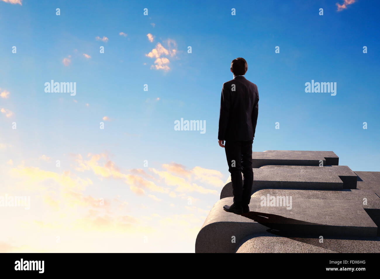Image of young businessman standing on top of building Stock Photo - Alamy