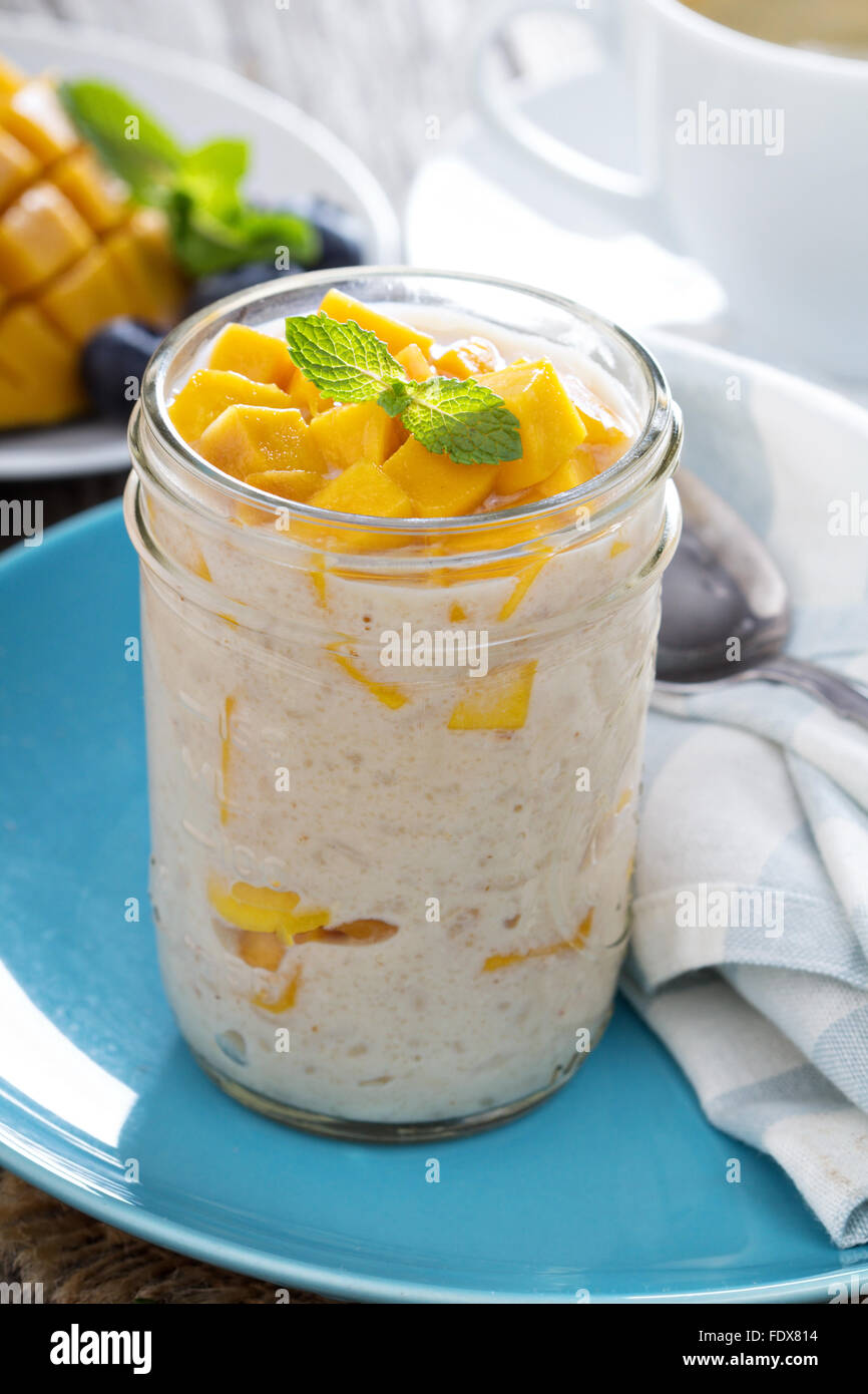 Coconut mango rice pudding served in a jar Stock Photo - Alamy