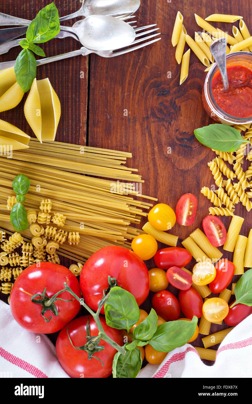 Pasta background different types with tomatoes and basil top view Stock ...
