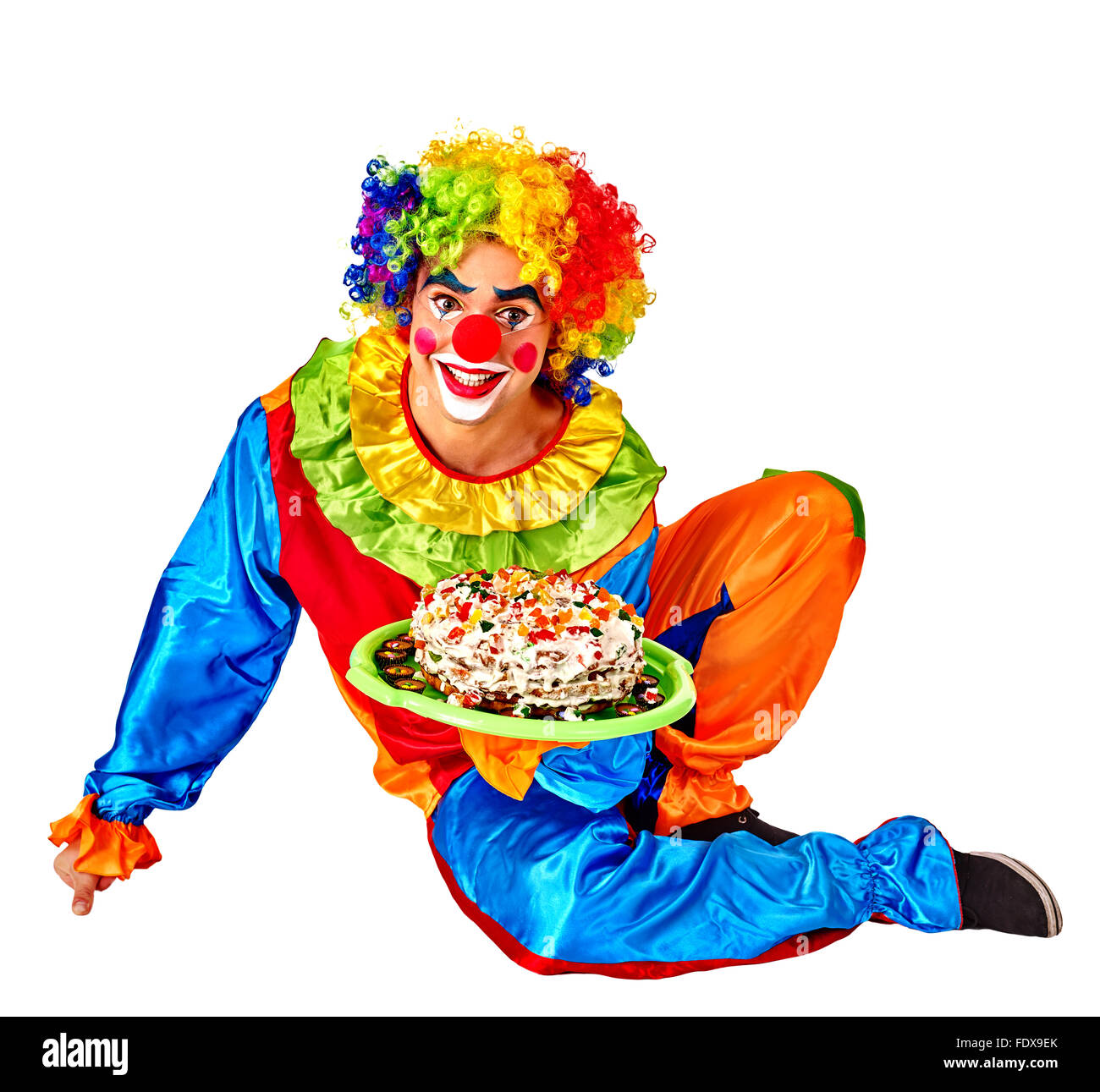 Happy male birthday clown holding cake Stock Photo - Alamy