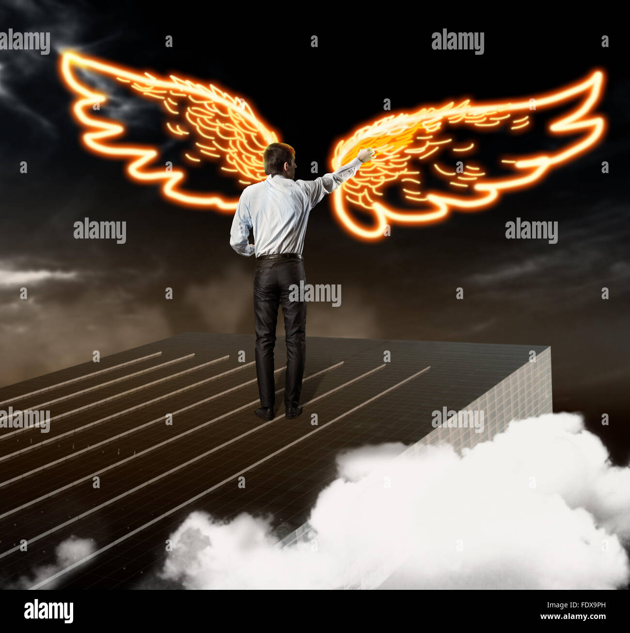 Back view of young businessman drawing wings Stock Photo - Alamy