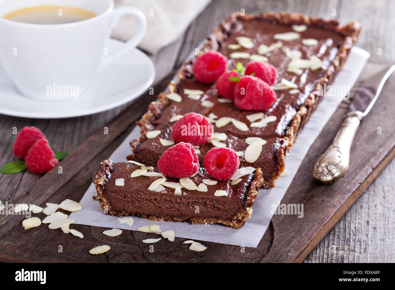 Vegan chocolate tart with almonds and a cup of coffee Stock Photo - Alamy