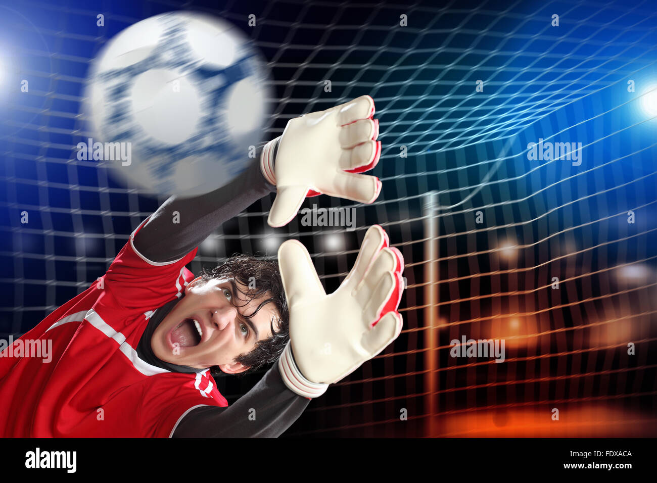 Goalkeeper catches the ball . At the stadium, in the spotlight Stock ...