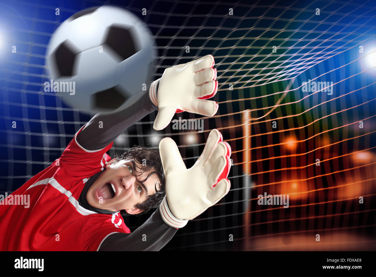 Goalkeeper catches the ball . At the stadium, in the spotlight Stock ...
