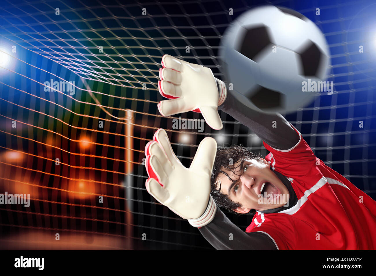 Goalkeeper catches the ball . At the stadium, in the spotlight Stock ...