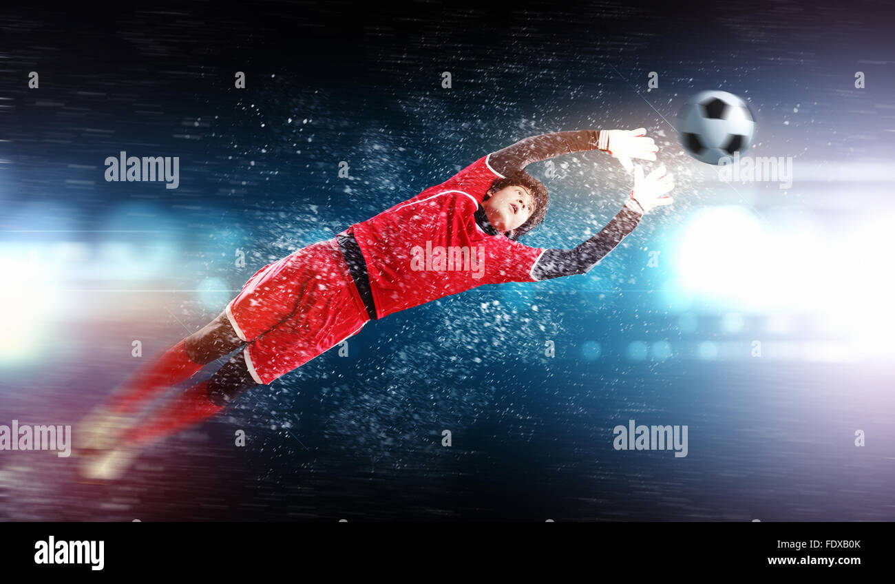Goalkeeper catches the ball . At the stadium, in the spotlight Stock ...