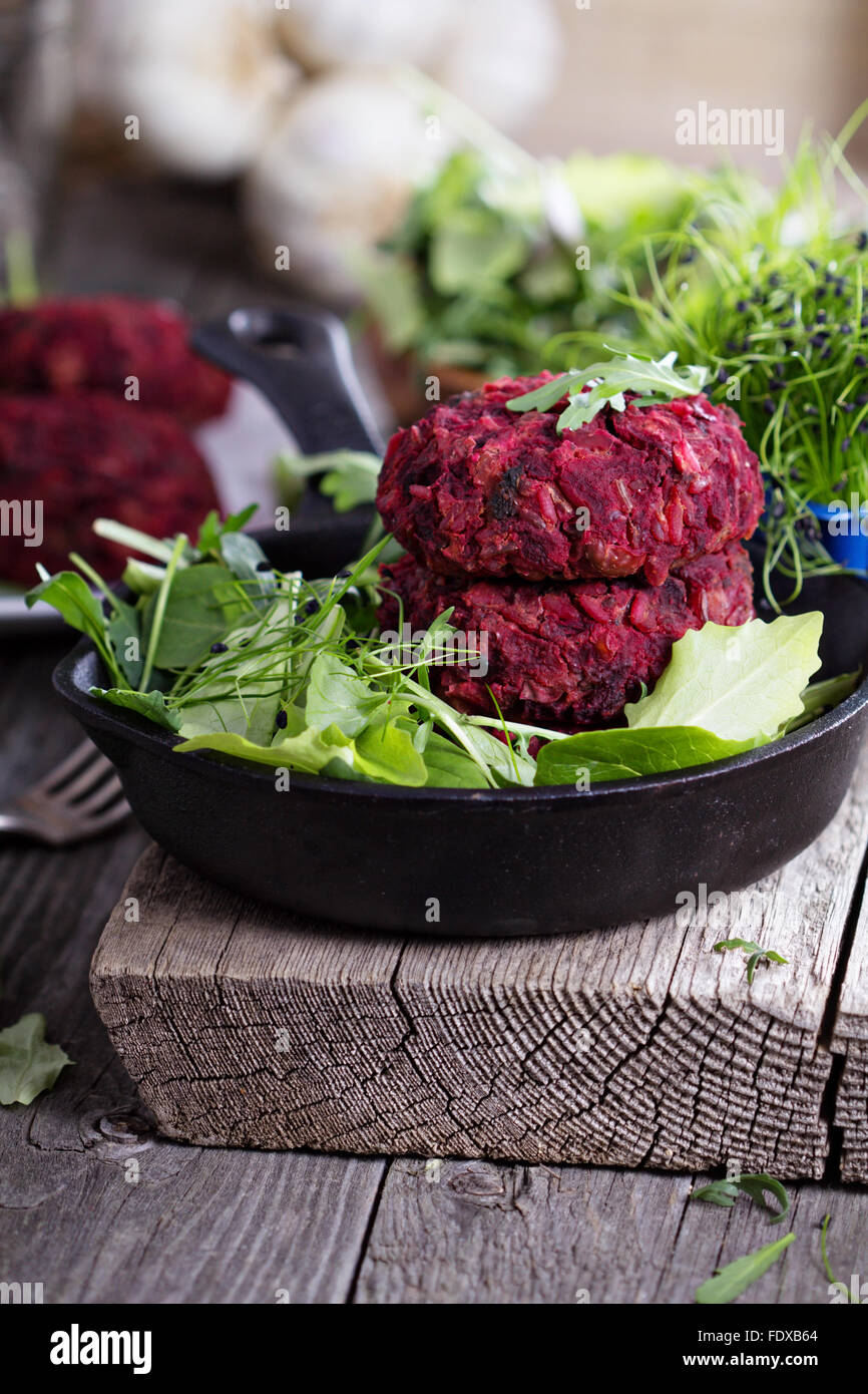 Beet root and red bean vegan burgers with salad Stock Photo - Alamy