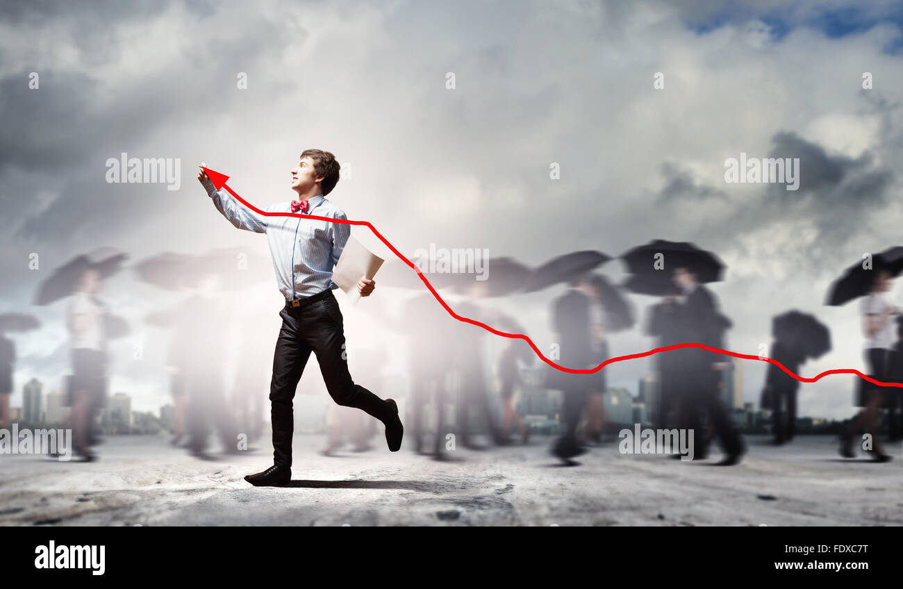 Image of young businessman drawing red graph Stock Photo - Alamy