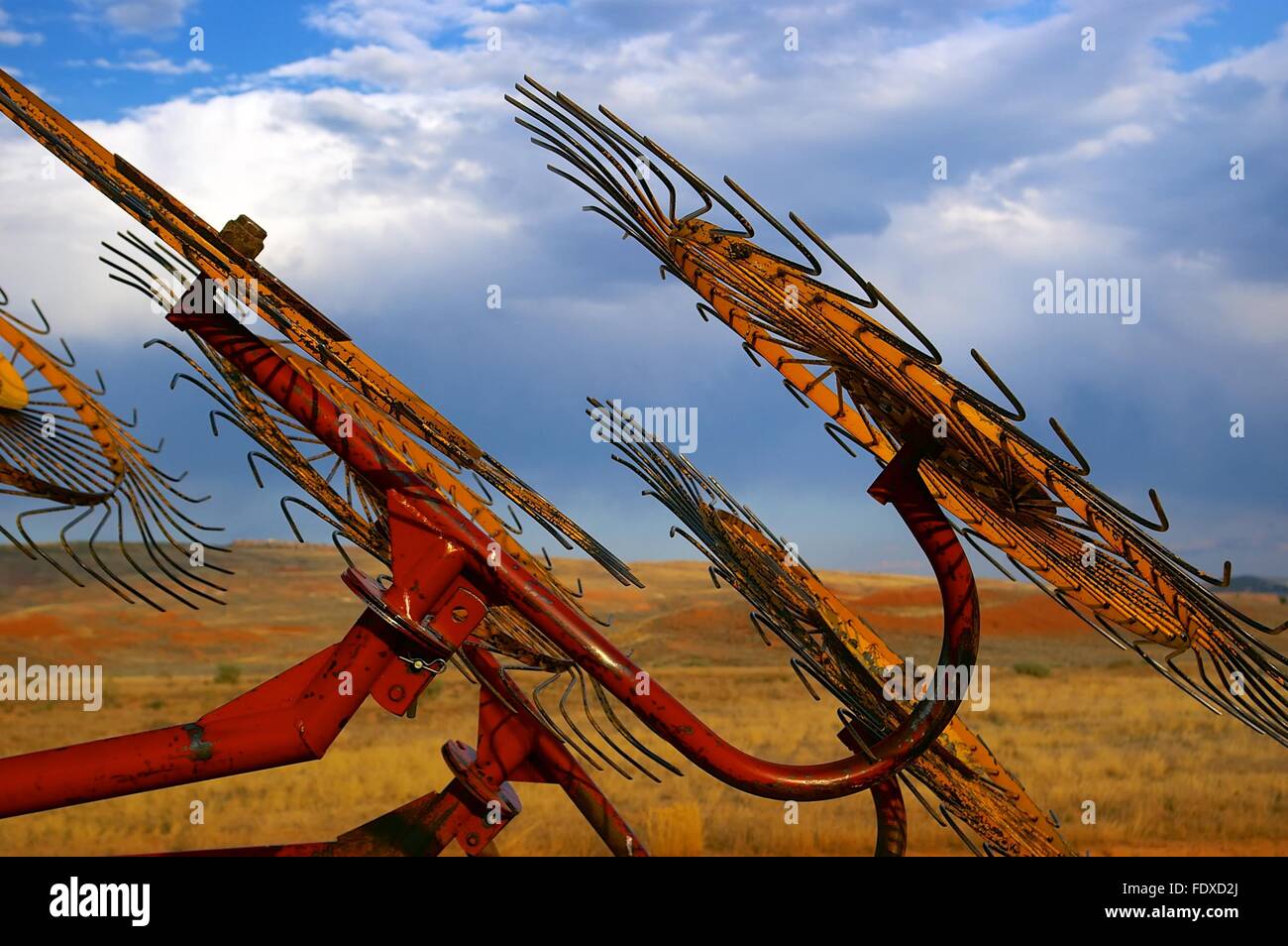 Side view of hay thrasher at sunset Stock Photo - Alamy
