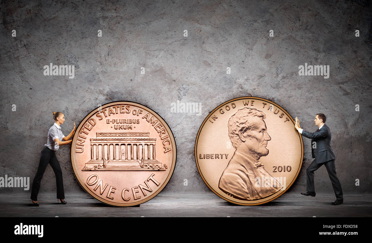 Two business people pulling coins. Currency concept Stock Photo - Alamy