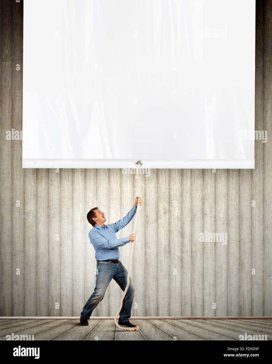 Adult man pulling blank banner. Place for text Stock Photo - Alamy